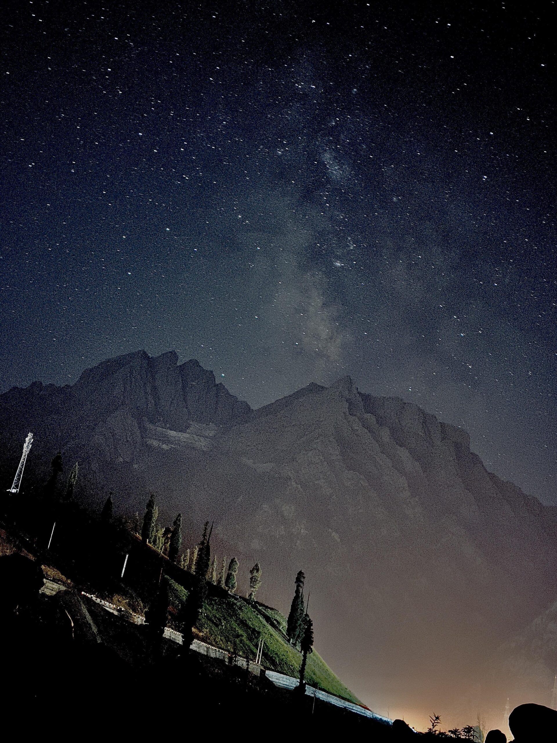 Hue of Milky Way Galaxy rising over a glacier,and many twinkling stars ...