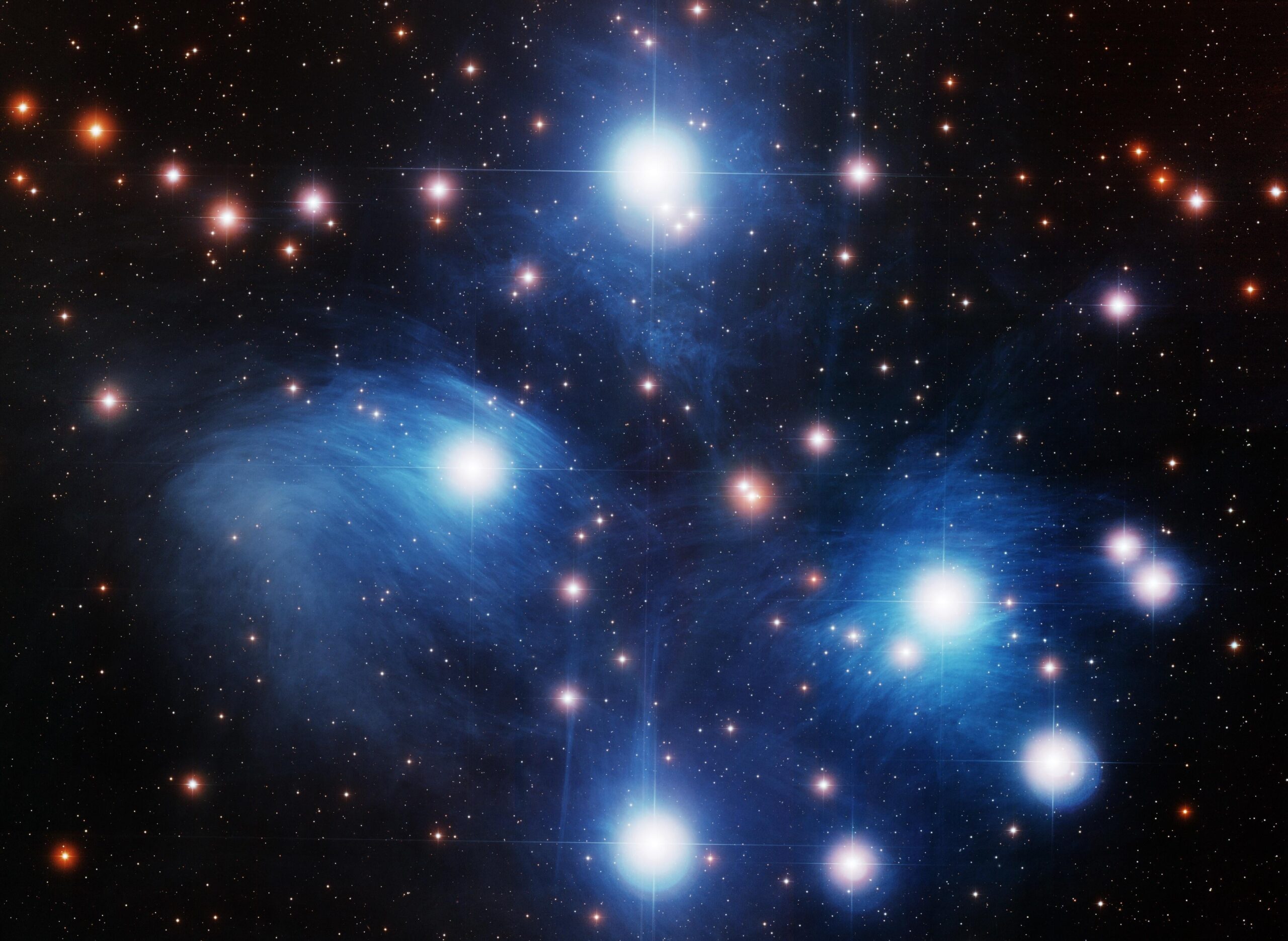 M45, the Pleiades, shimmers in a diffuse blue haze. That glow isn’t gas ...